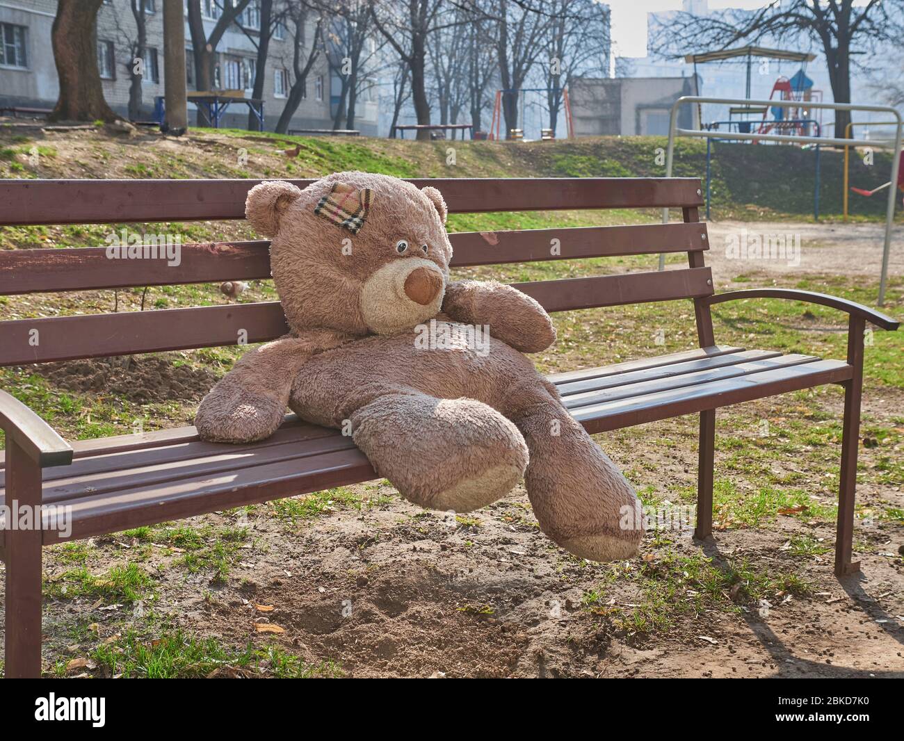 The big toy bear sitting on the bench alone. Longliess concept Stock ...