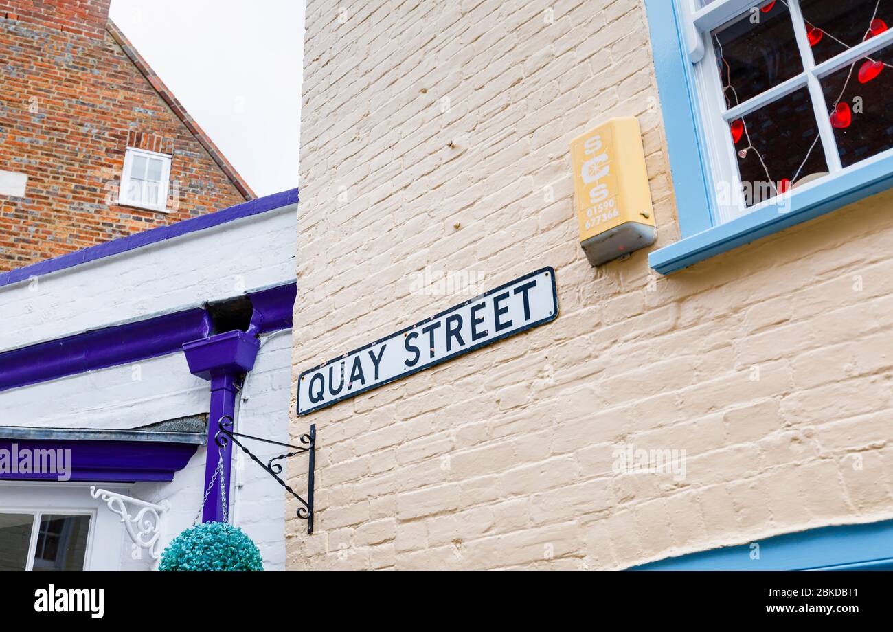 Street name sign of historic Quay Street on a wall, Lymington ...