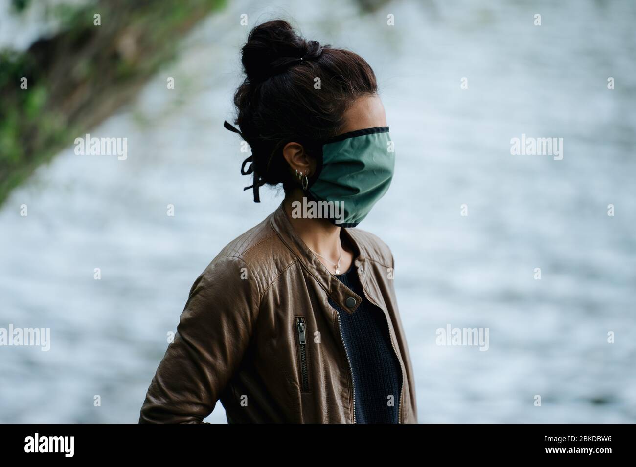 photo of a woman wearing a face mask covering her face Stock Photo - Alamy