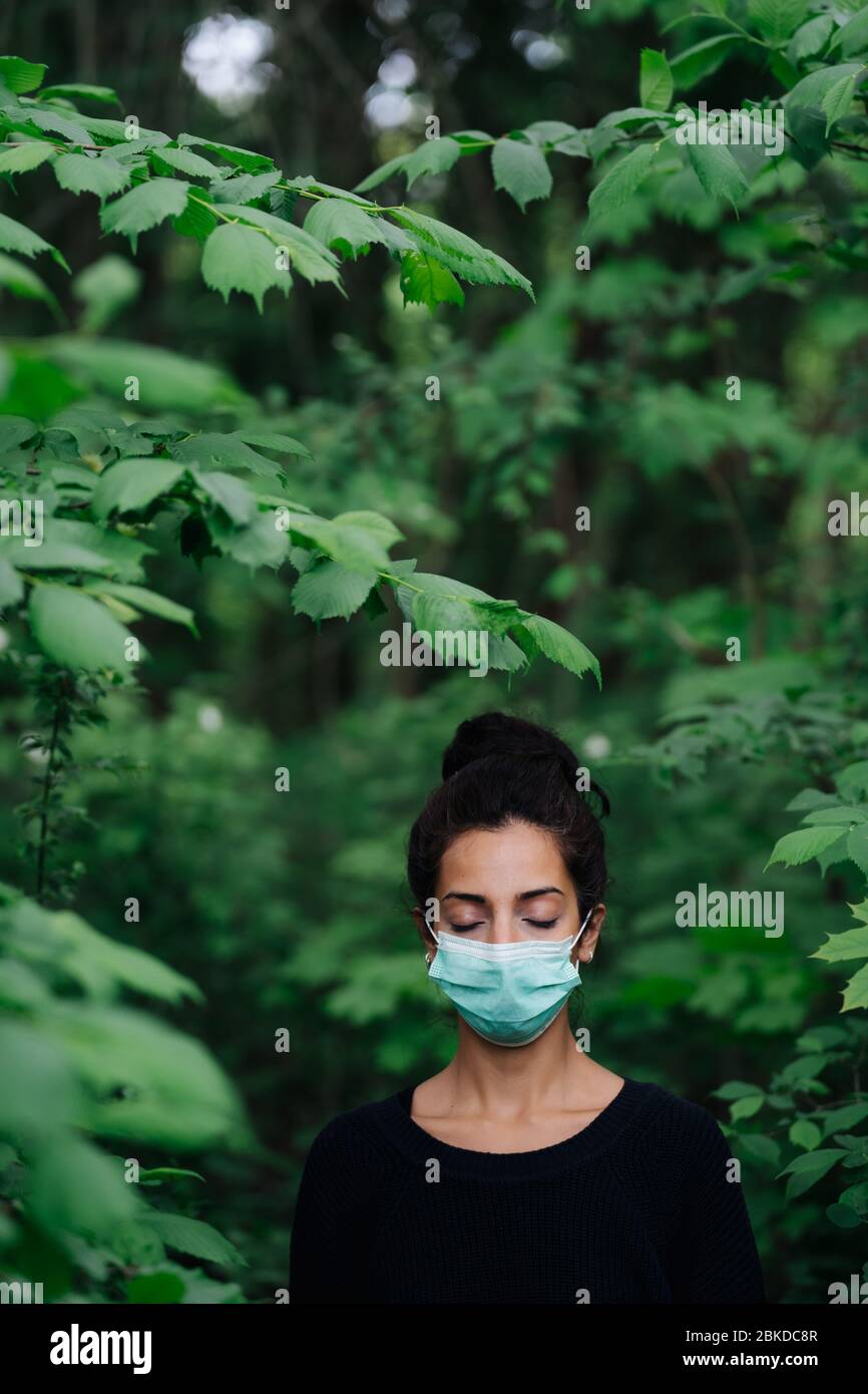 photo of woman in the forest with face mask Stock Photo - Alamy
