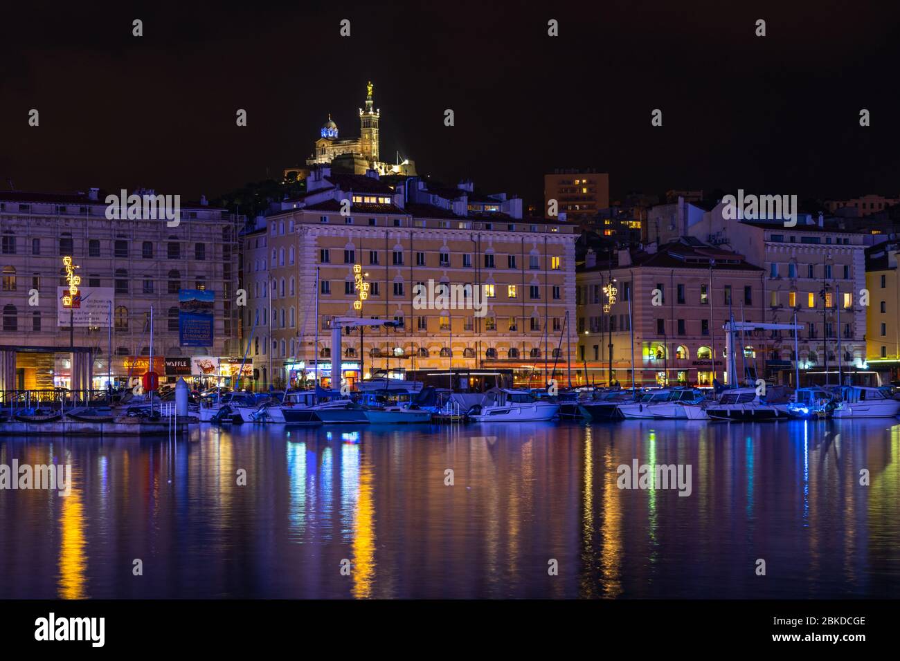 Cityscape of Marseille Vieux Port (old port) at night with the basilica ...
