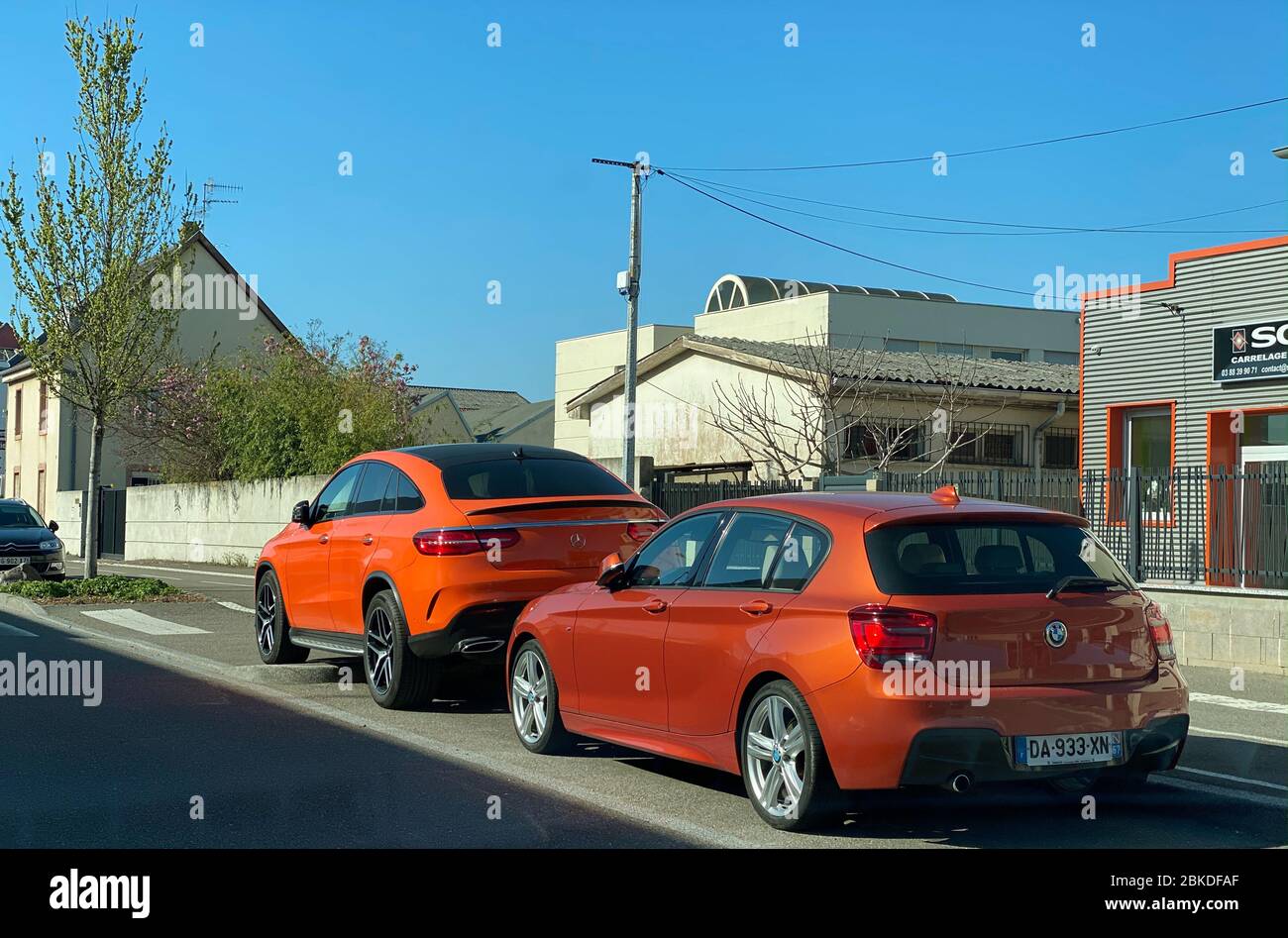 Strasbourg, France - Mar 24, 2020: Two German orange cars one BMW and ...