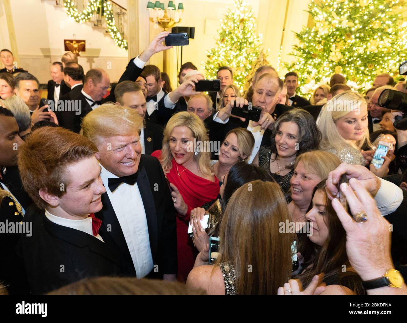 President Donald J. Trump poses for photos with guests Thursday evening ...