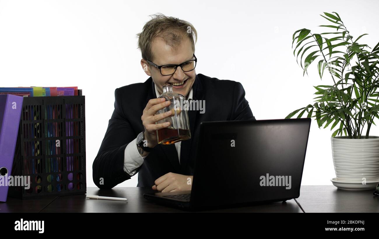 Tired disheveled clerk man working on laptop, toasting drinking alcohol ...