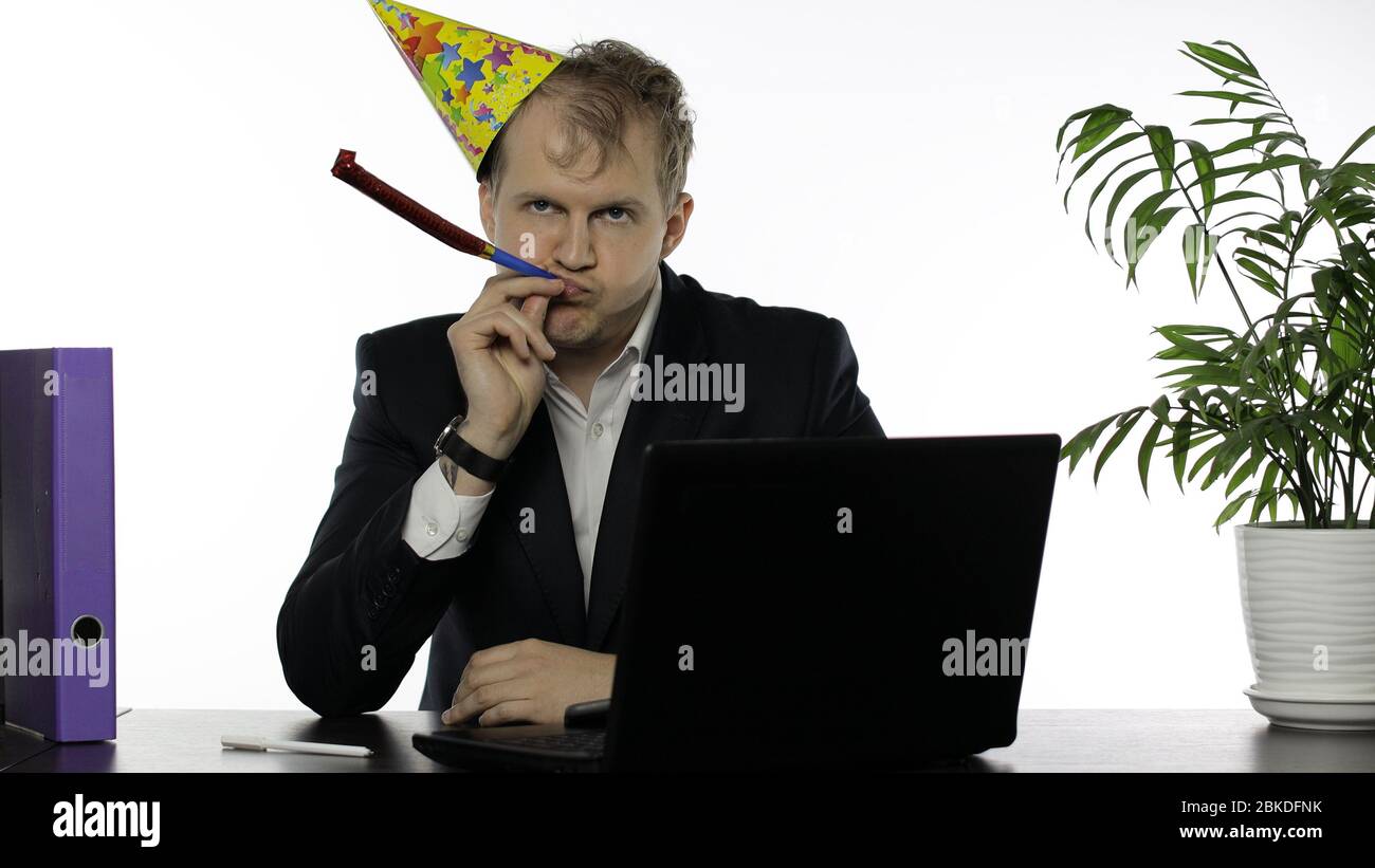 Drank sleepy young clerk man with hangover sitting at the office desk ...