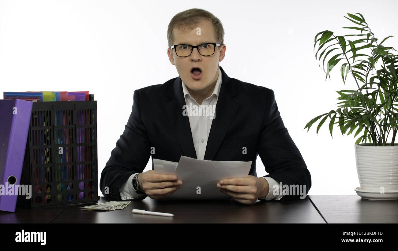 Young businessman manager sitting at office looking shocked. Office ...