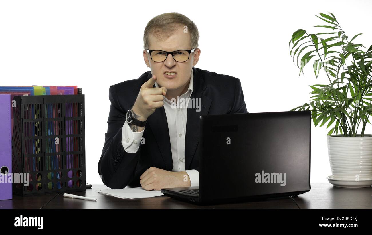 Irritated businessman boss at working desk in office blaming you points ...