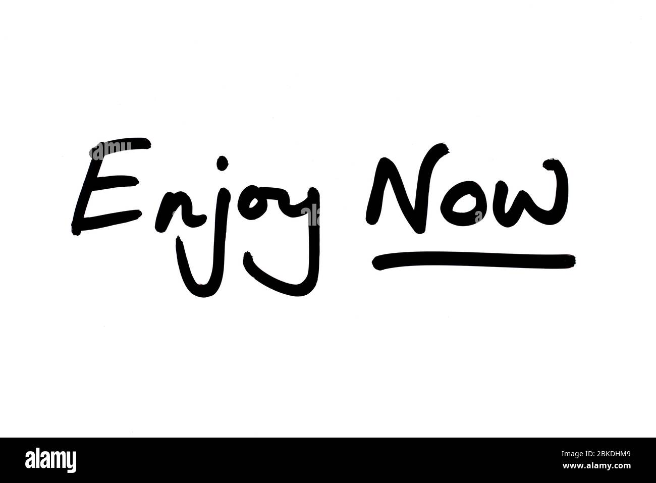 Enjoy NOW handwritten on a white background Stock Photo - Alamy