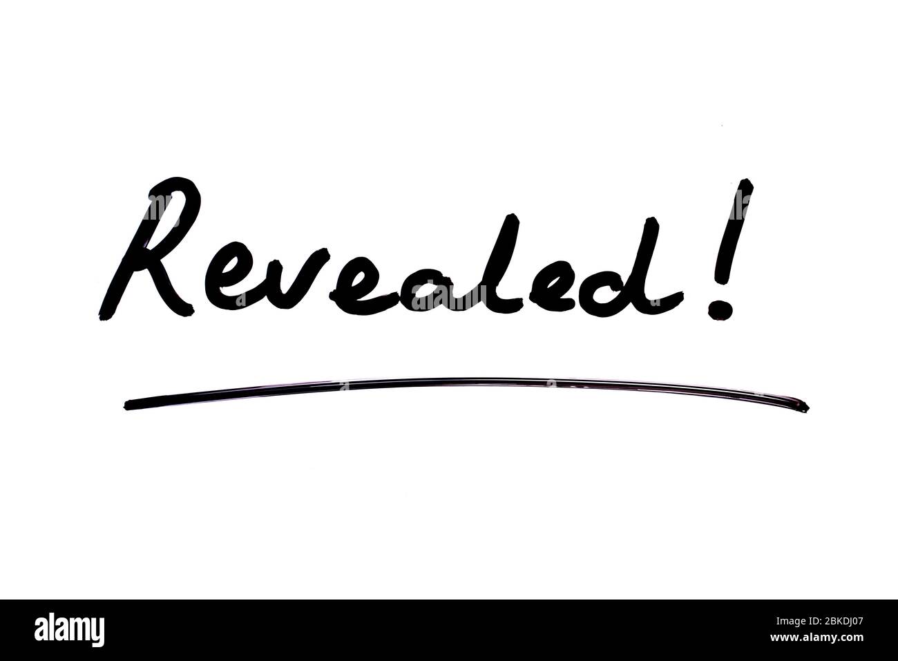 Revealed! handwritten on a white background Stock Photo - Alamy