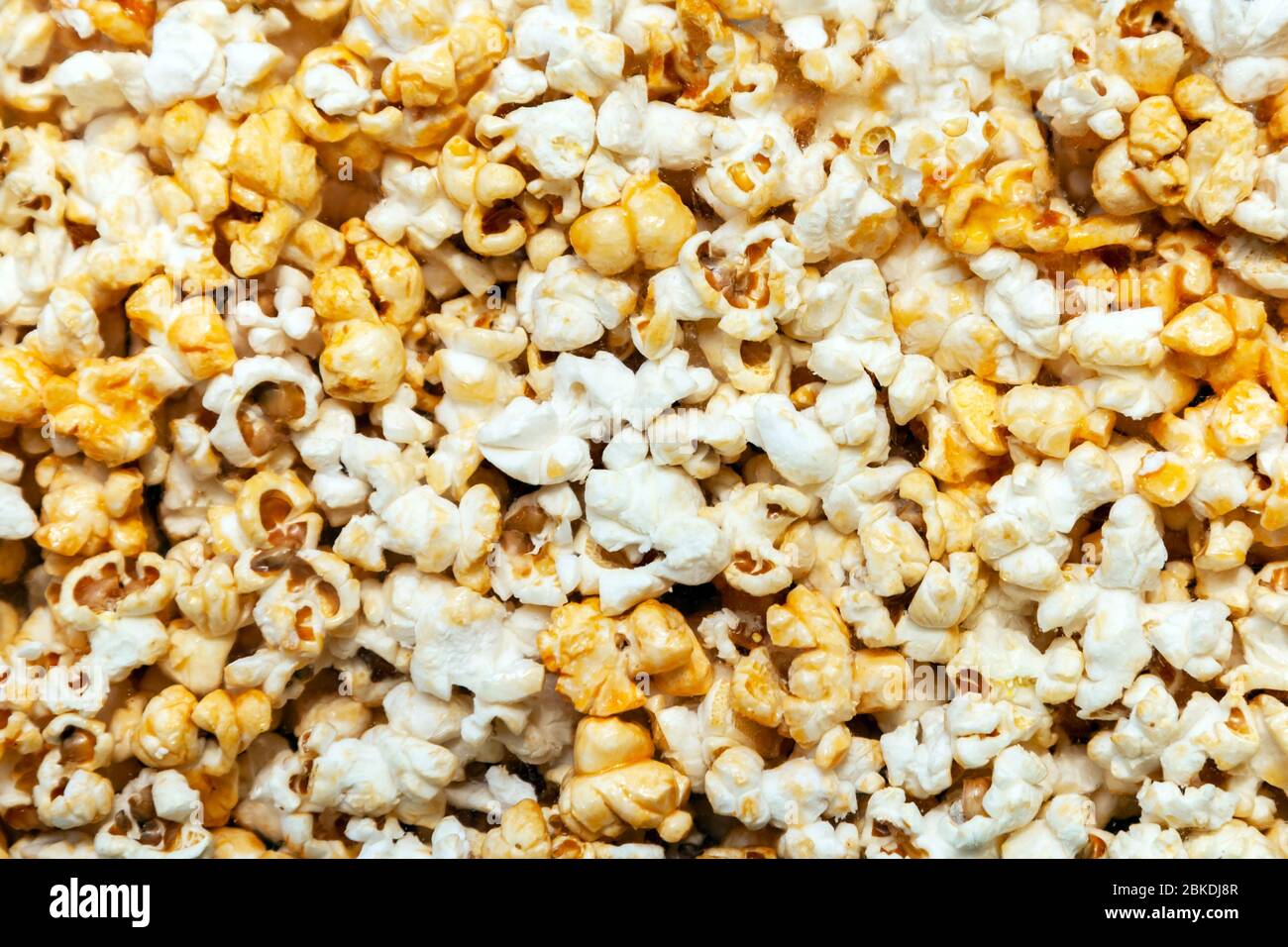 Popcorn texture background. A pile of pop corn behind the glass Stock ...