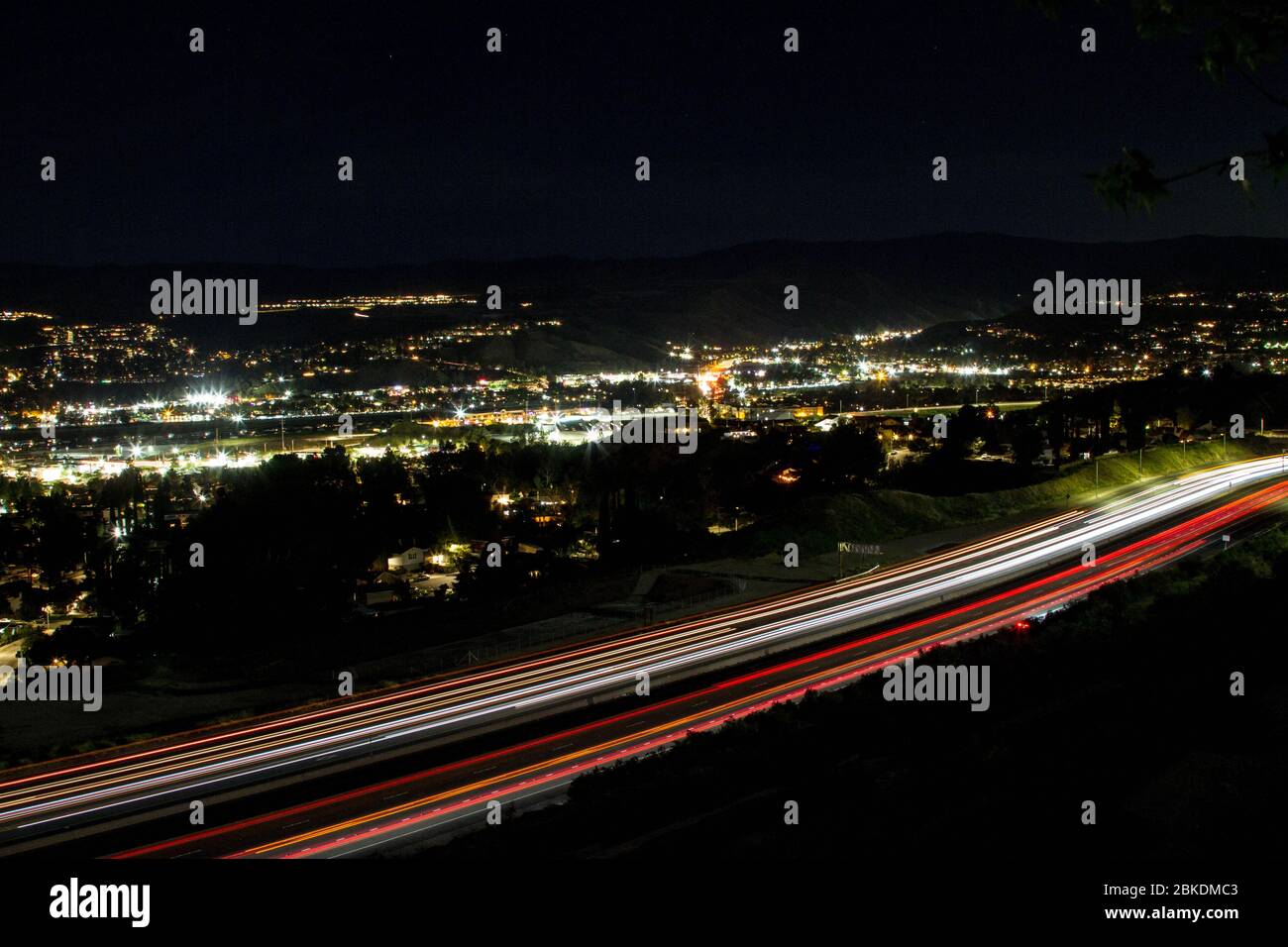 Freeway Lights with City Stock Photo - Alamy