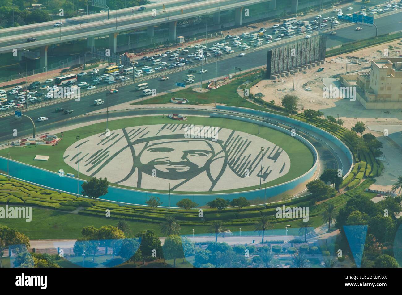 Aerial View of Dubai with Sheikh Zayed Road behind with design on lawn ...