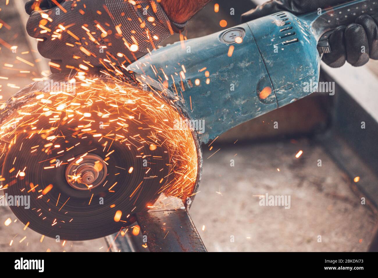 Construction worker using Angle Grinder cutting Metal at construction ...