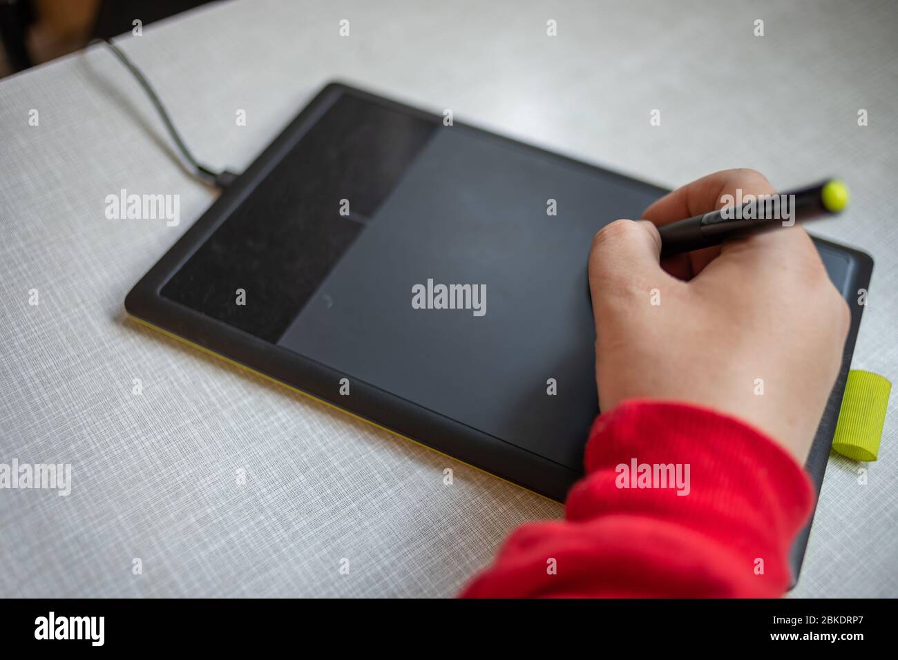 Graphic table and pen in hand of artist. Digital Drawing and ...