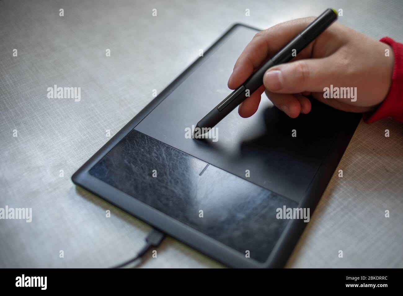 Graphic table and pen in hand of artist. Digital Drawing and ...