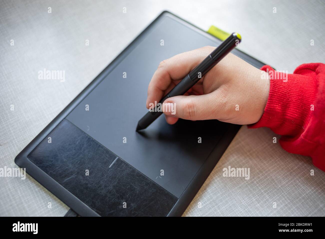 Graphic table and pen in hand of artist. Digital Drawing and ...