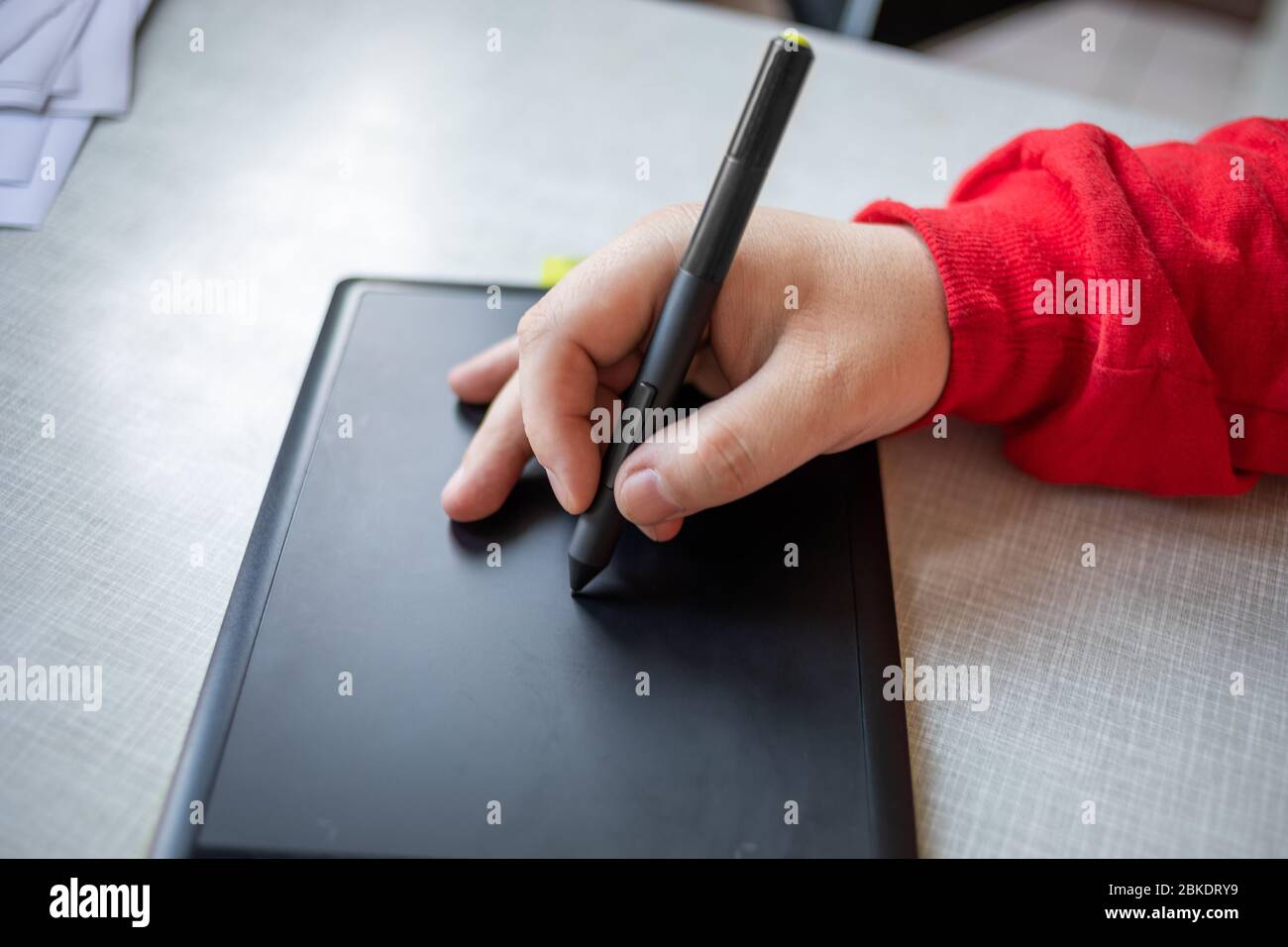 Graphic table and pen in hand of artist. Digital Drawing and ...