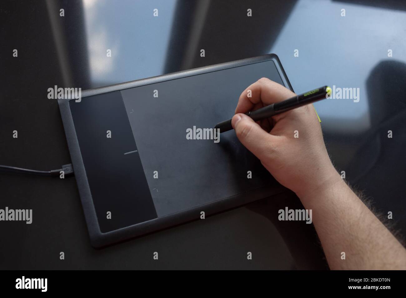 Graphic table and pen in hand of artist. Digital Drawing and ...