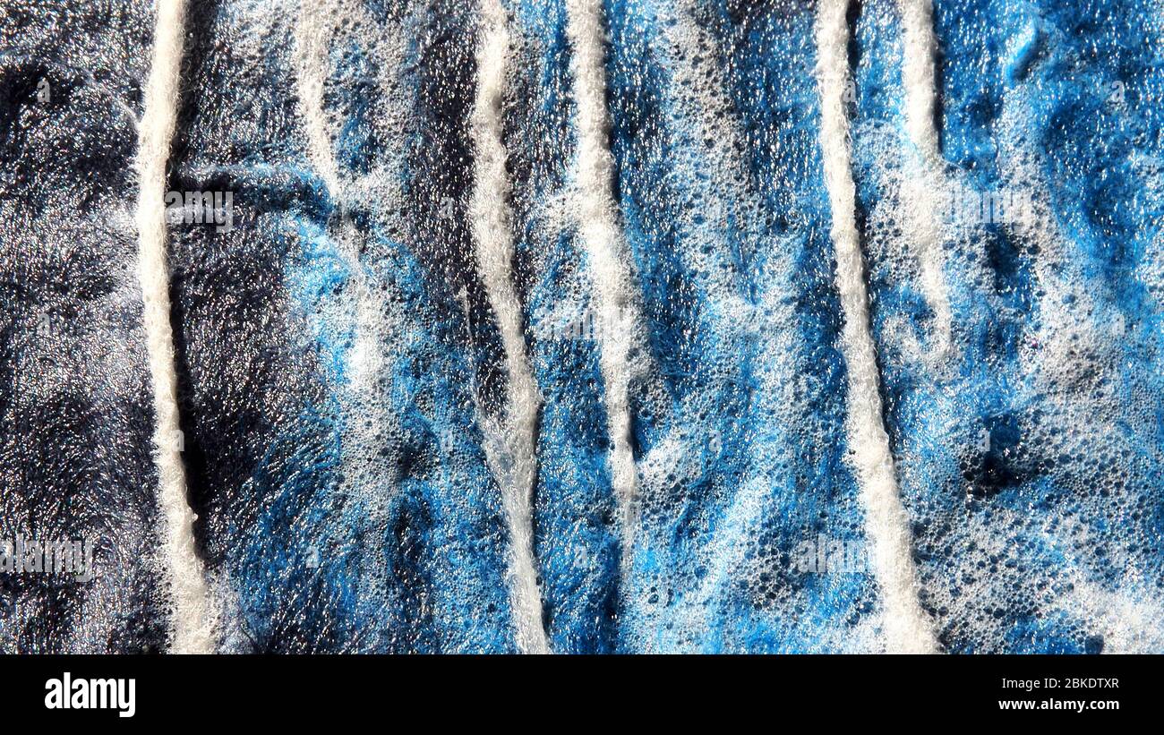 Merino wool being wet felted with sudsy water for a garment by textile ...