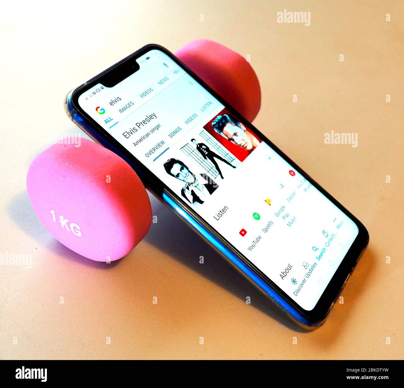 A 1kg weight doubles as a phone stand Stock Photo - Alamy