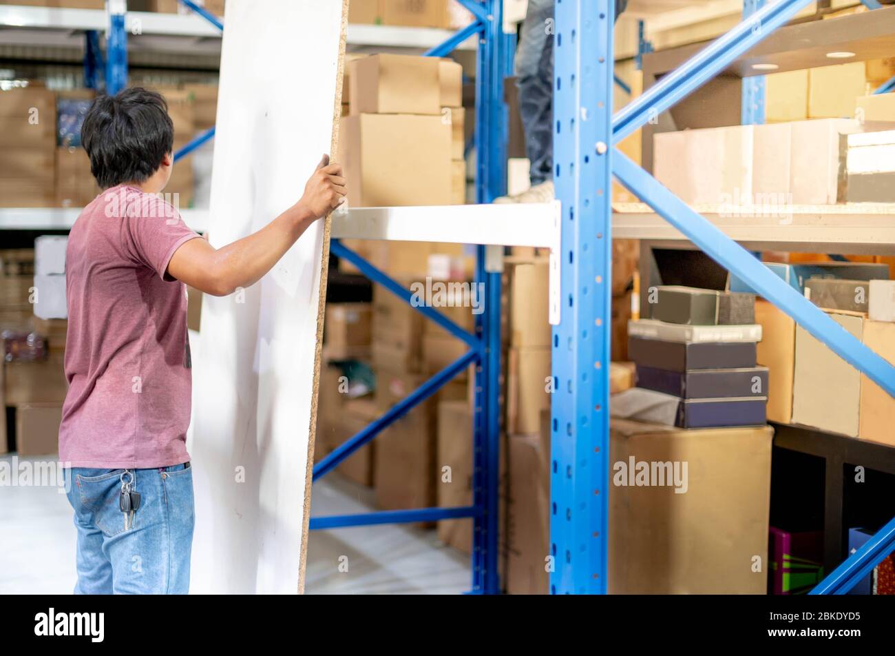 Male hand holding prepare to assembling woodboard for put on the metal ...