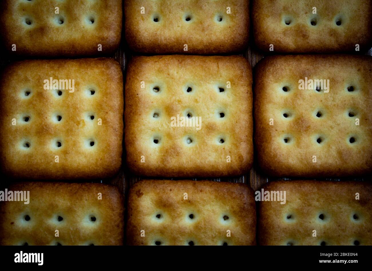 Top view of crispy square shaped biscuits. Salt and sweet biscuits ...