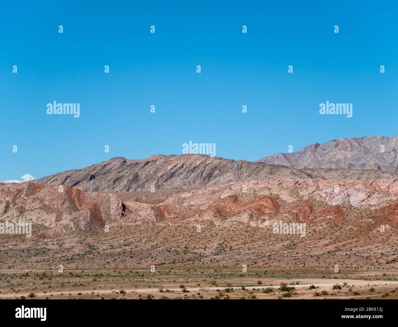 Scalloped striations of hillside erosion show layers of red rock Stock ...