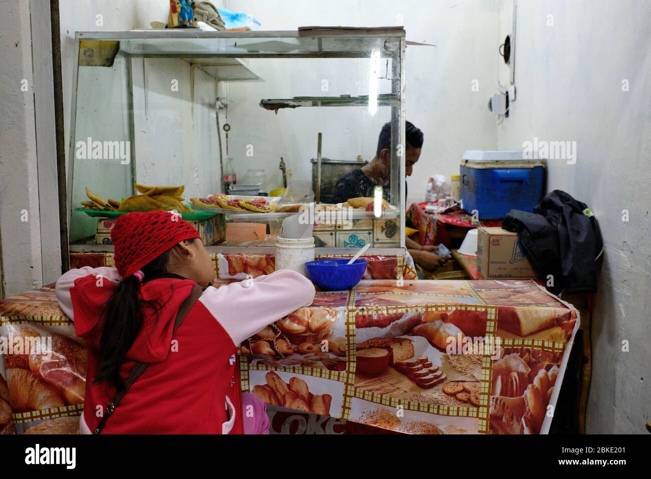 Young girl taking a nap on the table of a small restaurant in the ...