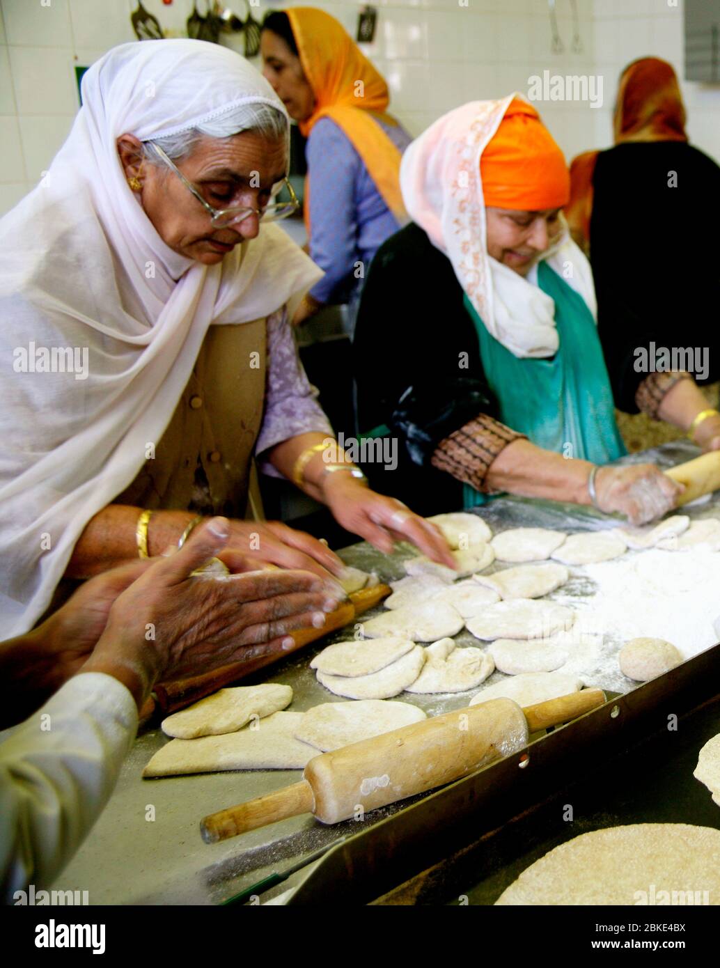 Sikh women preparing langar in the gurdwara which people will eat ...