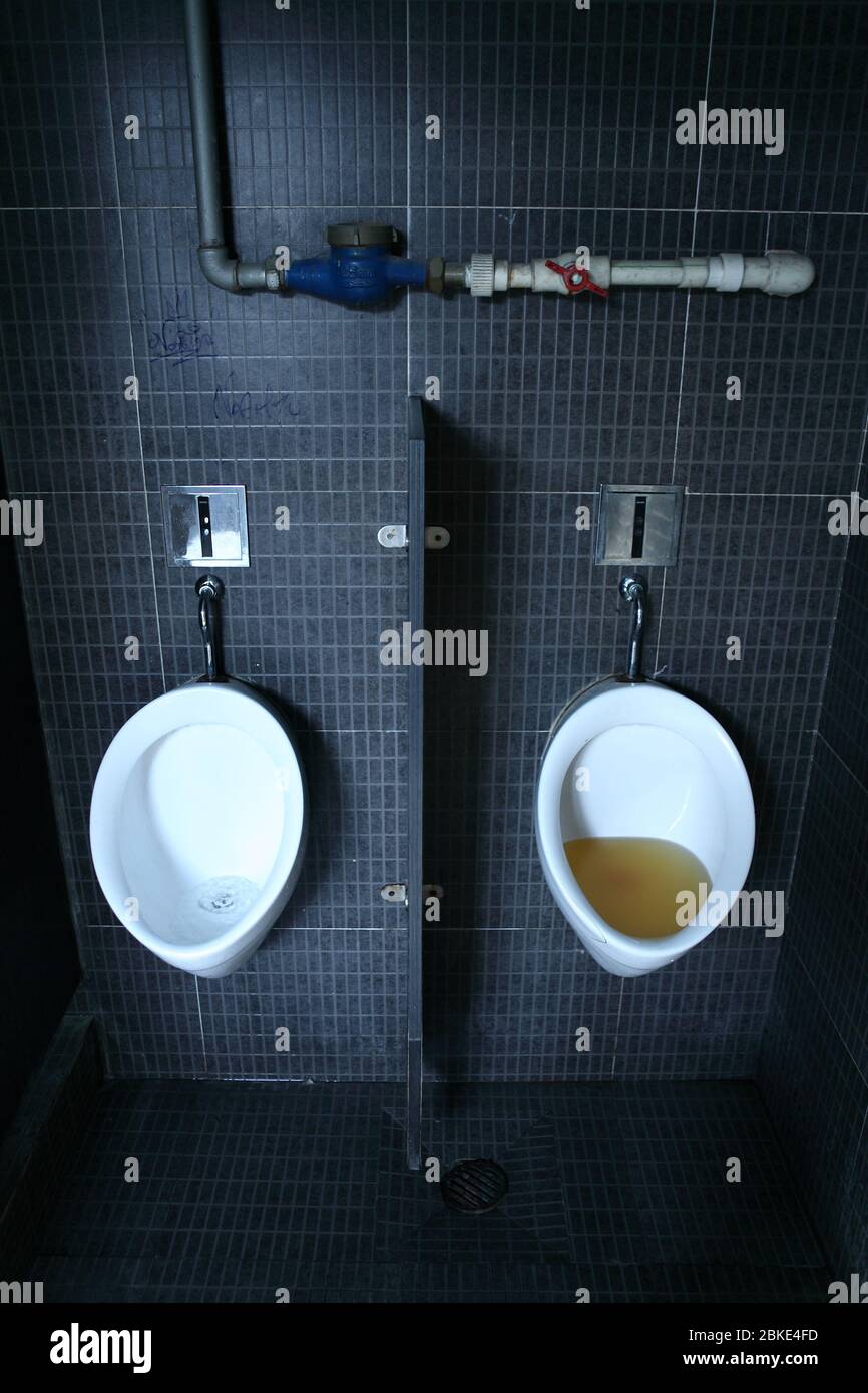 Inside the gent toilet to see a urinal is flushing properly and clean ...