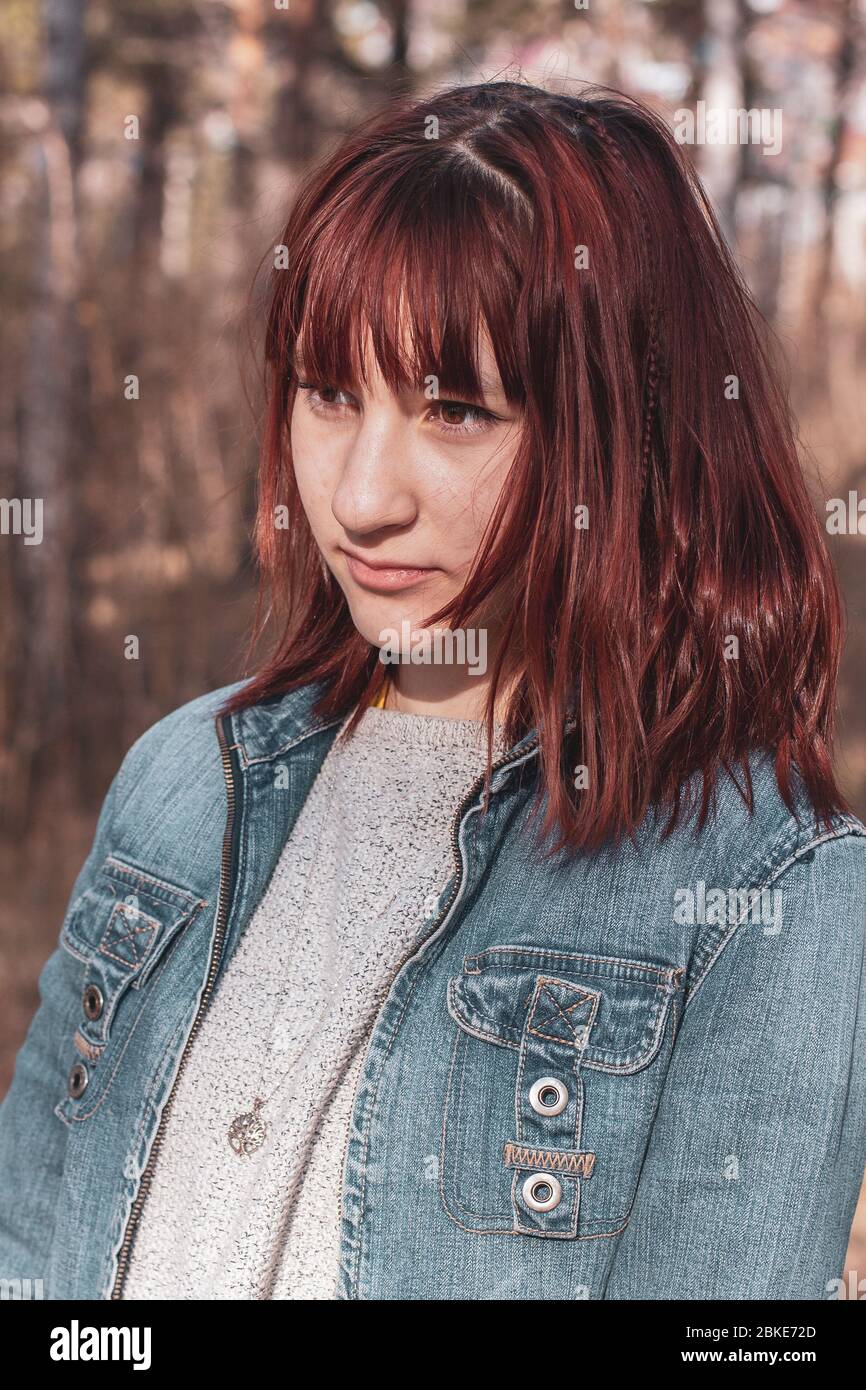 Portrait of a pensive young girl with red hair. European appearance ...