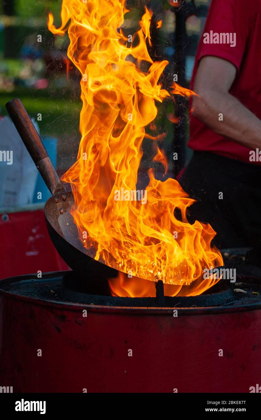 Cooking street food on a hot frying pan. Street food festival Stock ...