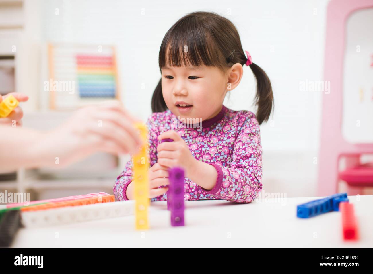 toddler girl play number blocks for homeschooling Stock Photo - Alamy