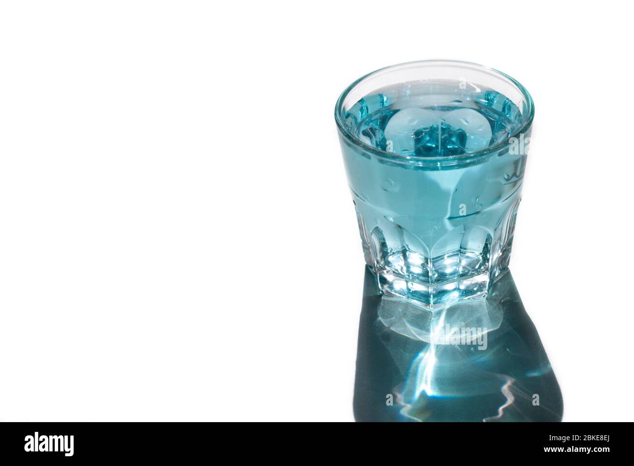 glass with blue water, bright shadow. Refreshing drink Stock Photo - Alamy