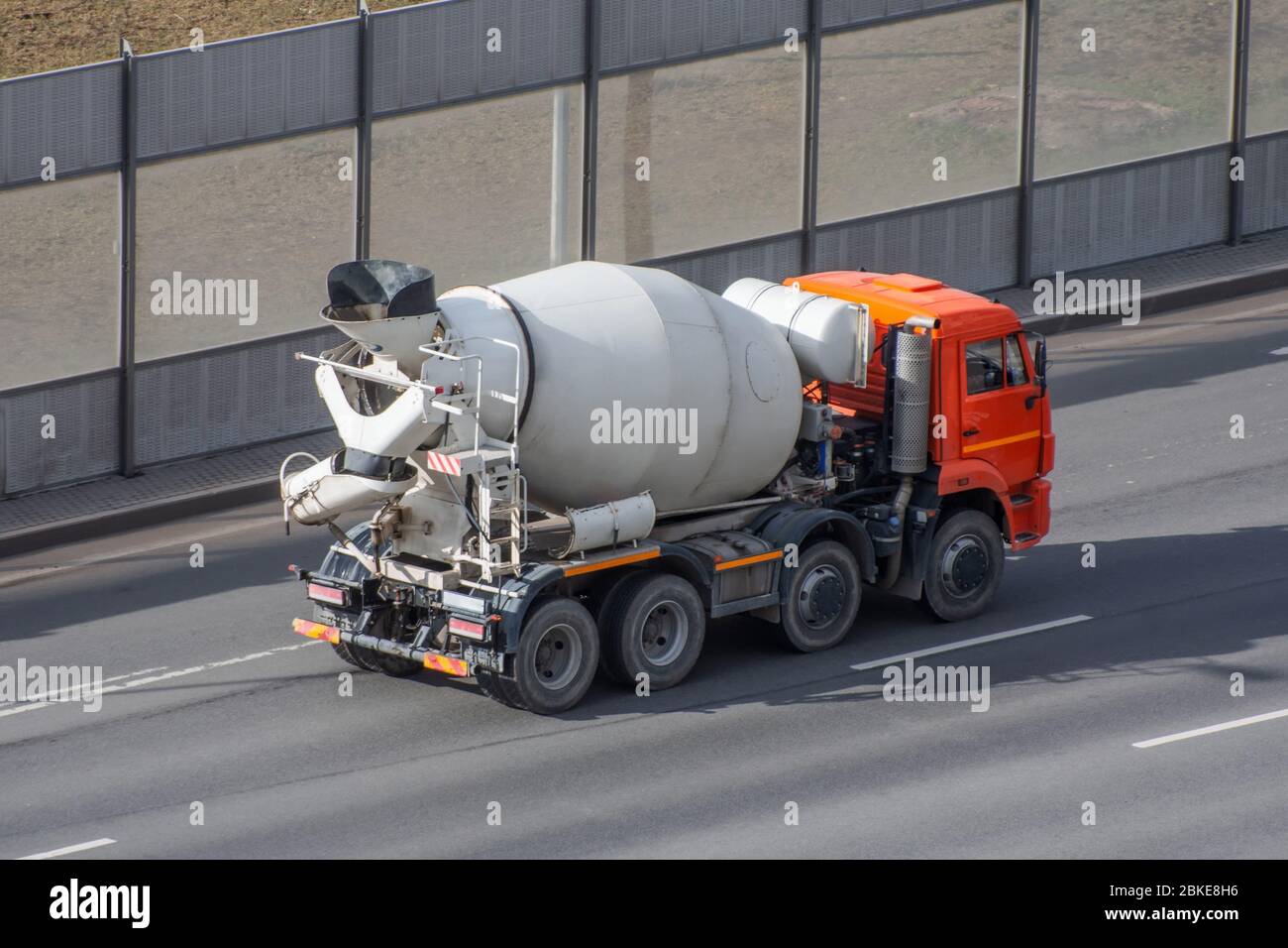 Concrete mixer truck rides on city highway Stock Photo - Alamy