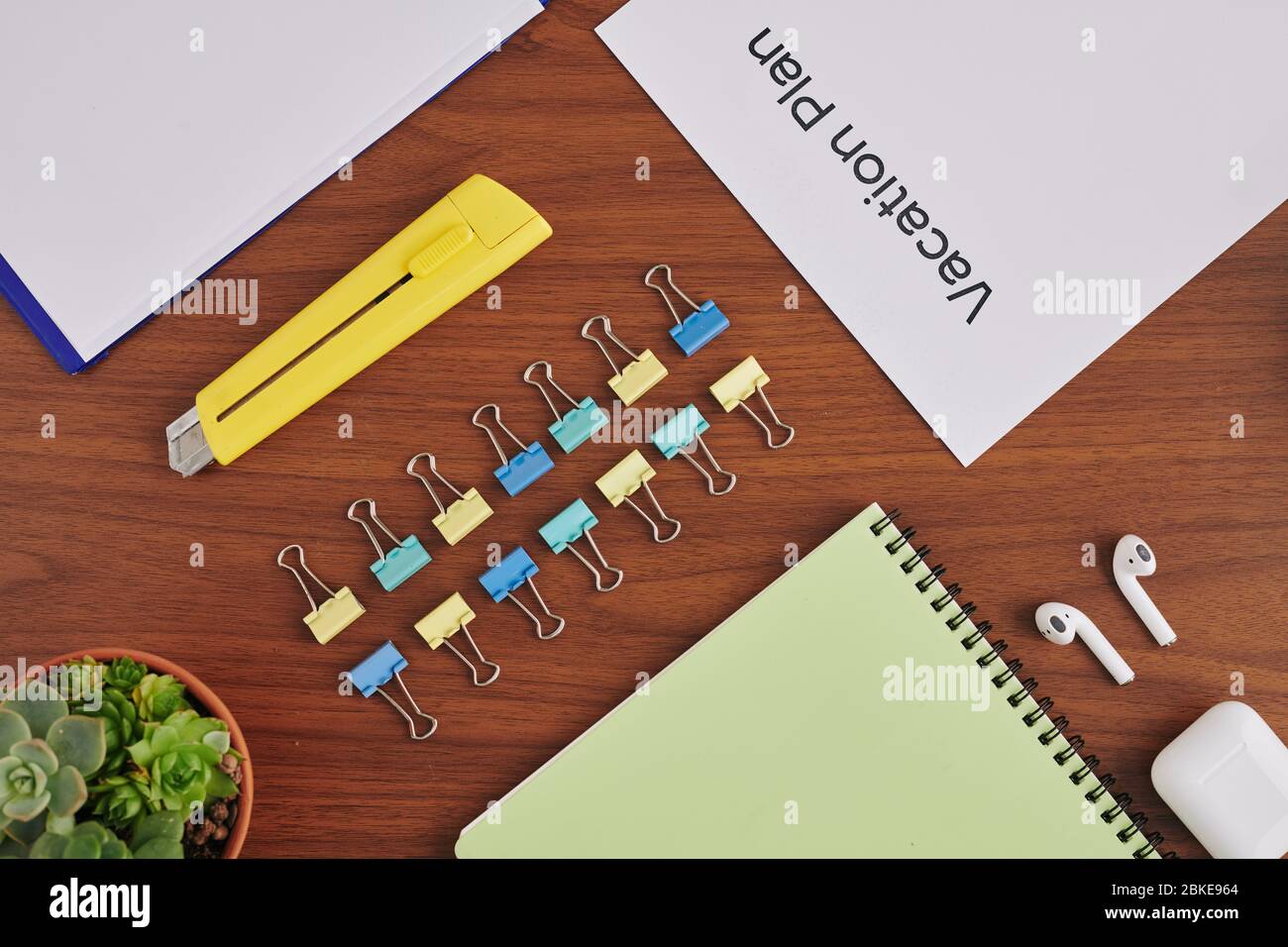 Modern desk of business person with paper clips, paper cutter, vacation ...