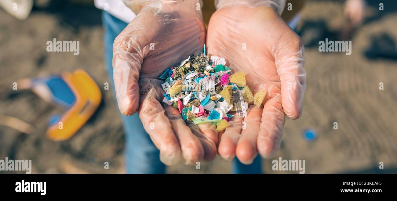 Hands with microplastics on the beach Stock Photo - Alamy