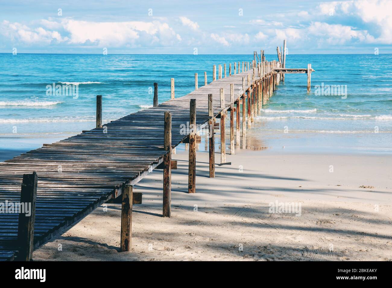 Wooden bridge on the beach at sea with sunlight Stock Photo - Alamy