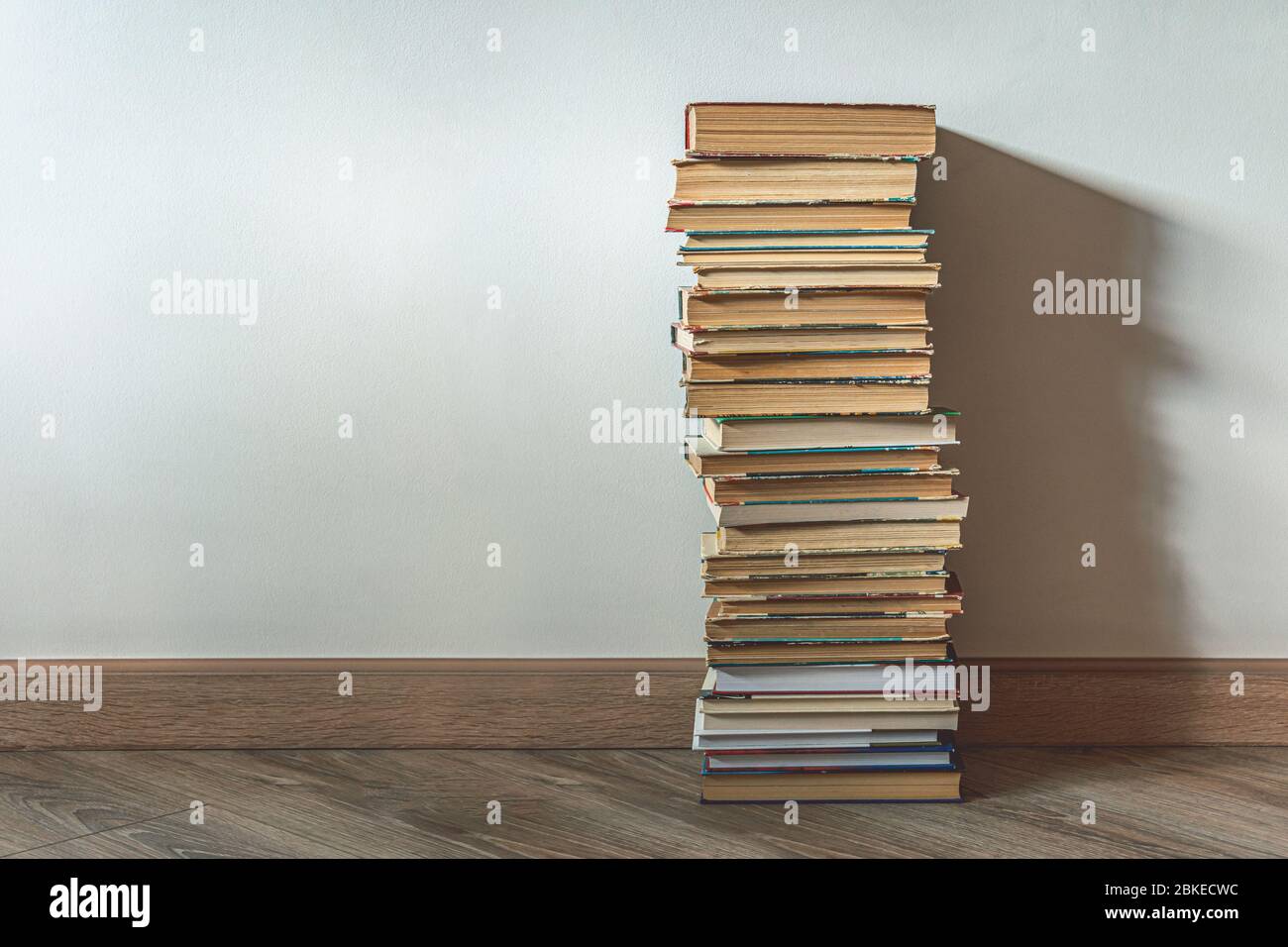 Big stack of old books over white wall, education concept, with copy ...