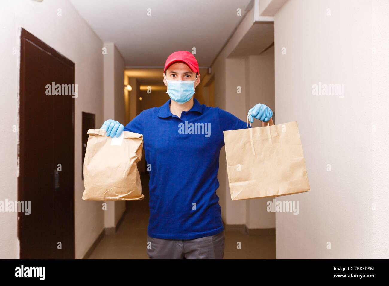 food delivery man in protective mask Stock Photo - Alamy