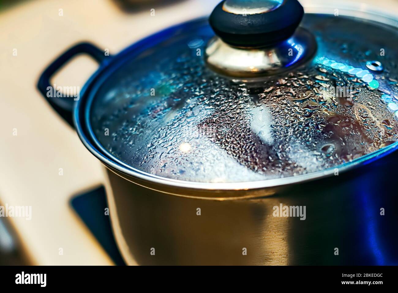 Metal pan with misted lid. Water droplets on the dishes during cooking ...