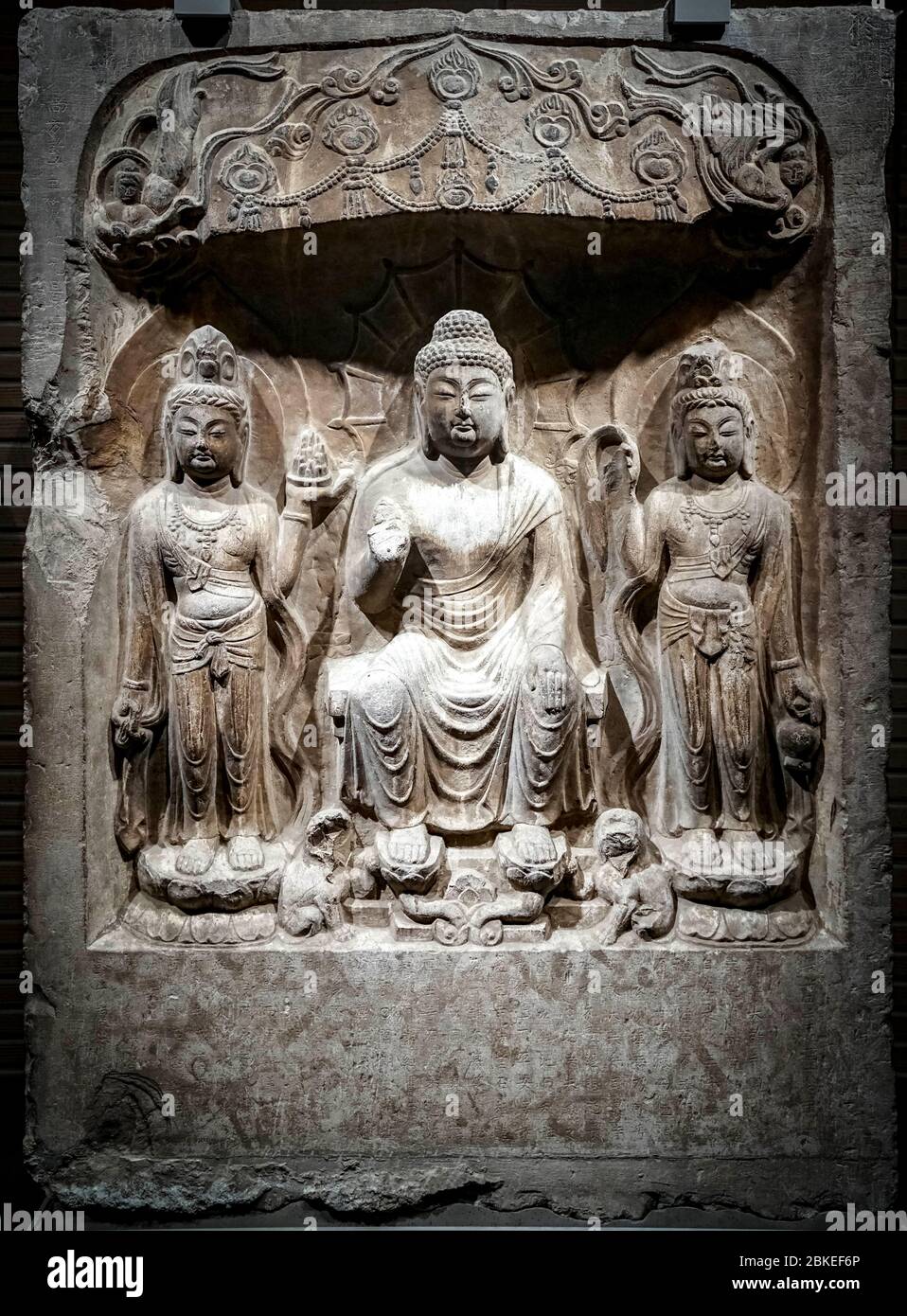 Buddha triad in a niche, carving on limestone from Baoqingsi temple, Xi ...