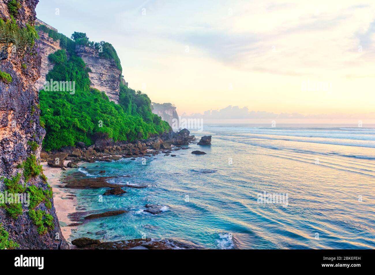 Beach at the foot of the cliff. Scenic view of a secluded rocky beach ...