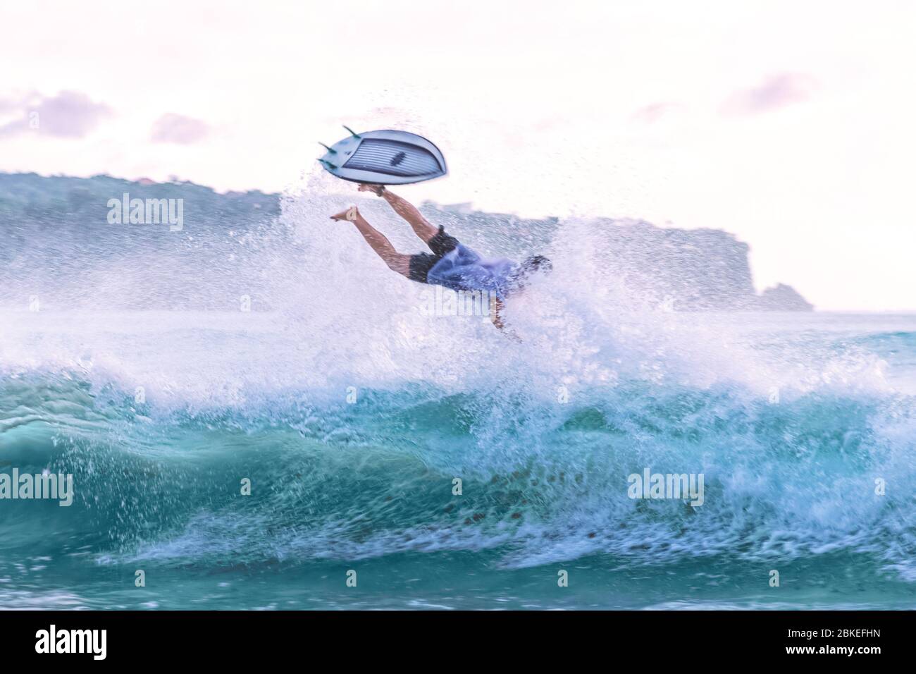 Surfer falling in the water. Blurred in motion photo. Big wave and ...