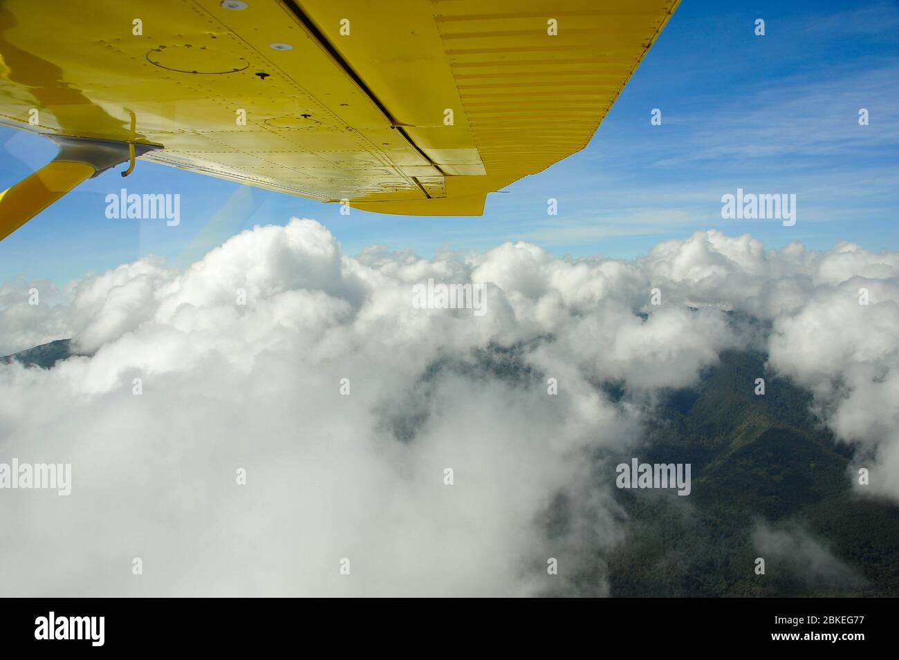 Aerial view from a bright yellow, aircraft. Beautiful scene with wing ...