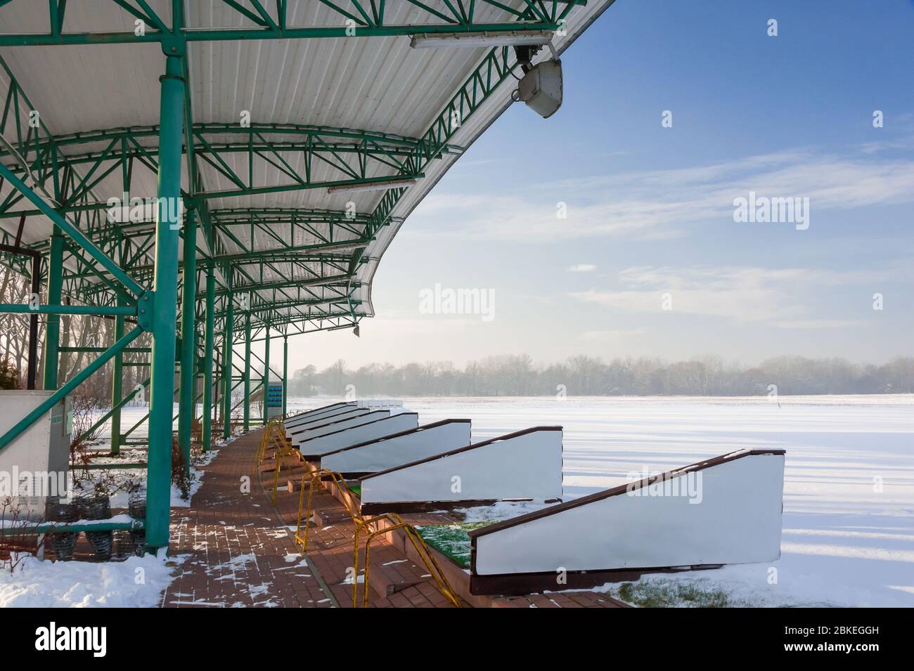Deserted golf driving range in winter. Snow covered landscape, with ...