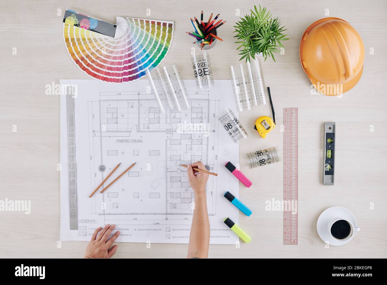 Construction engineer checking house blueprint, making corrections and ...