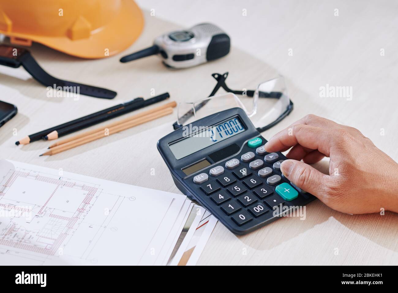 Engineer working at his table and making calculations when checking ...