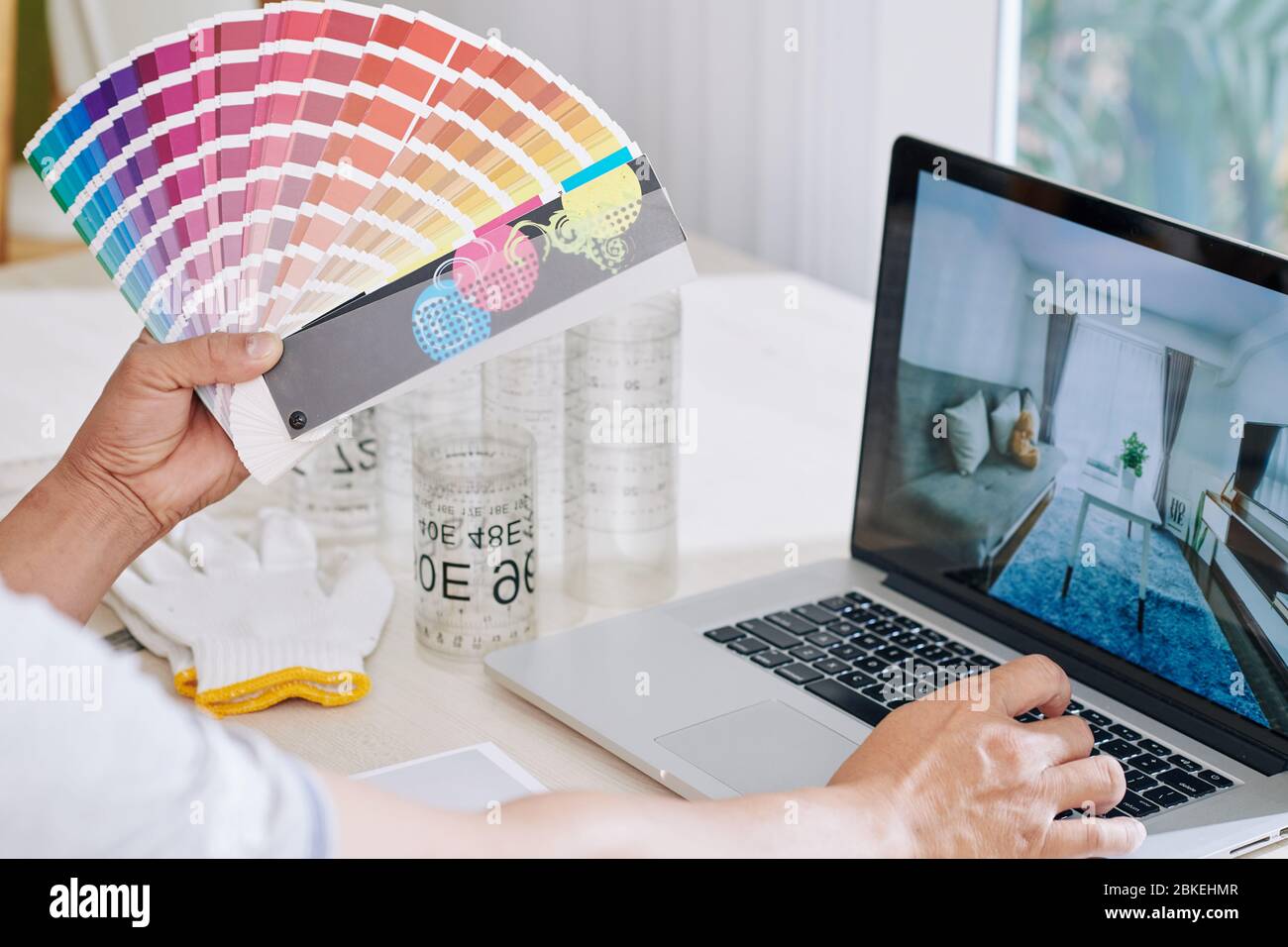 Interior designer looking at inspiring photos on laptop screen and ...