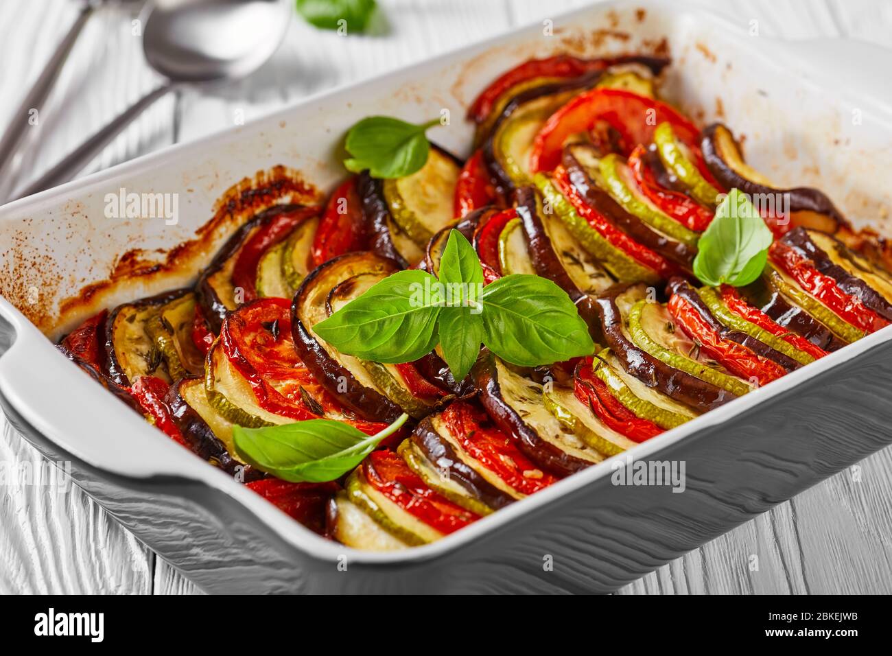close-up of french tian provencal, baked sliced layered vegetables in a ...